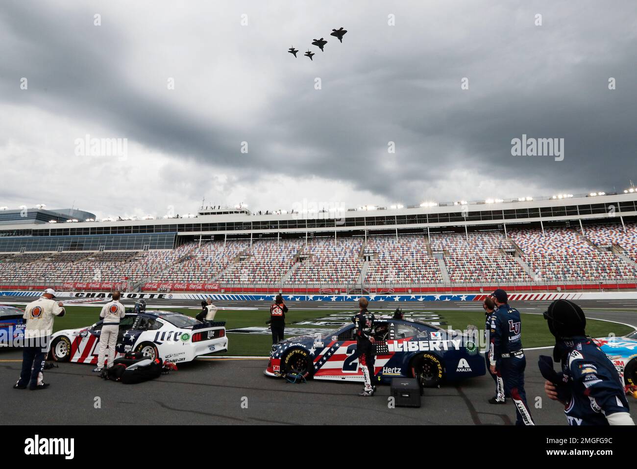 Military jets fly over Charlotte Motor Speedway before the start of the ...