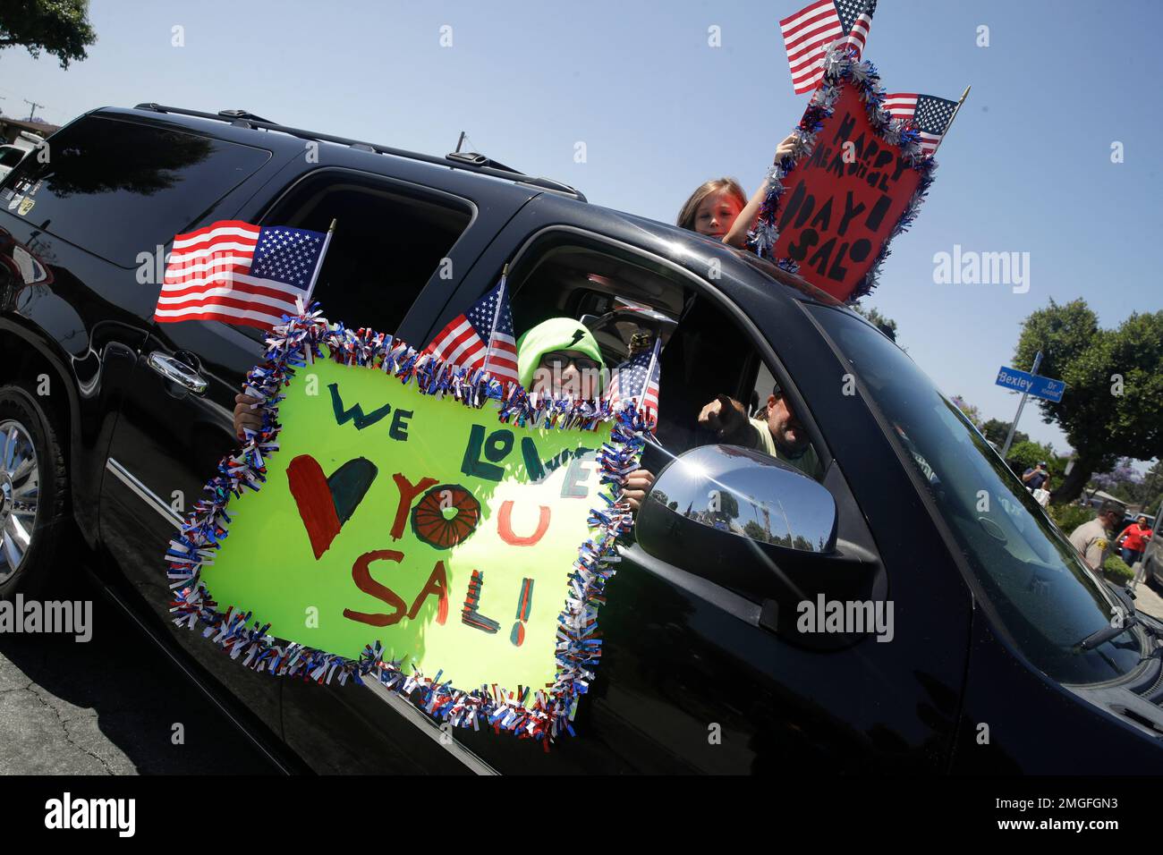 Chase Pierce, top, and his twin brother Austin, 10 wave signs for WWII ...