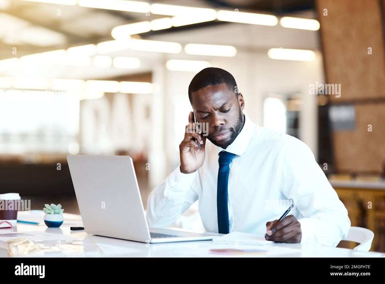 Taking the calls like a boss. a focused young businessman talking on ...