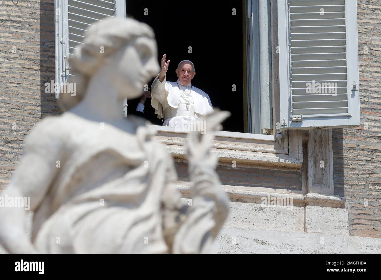 Pope Francis delivers his blessing from the window of his studio ...