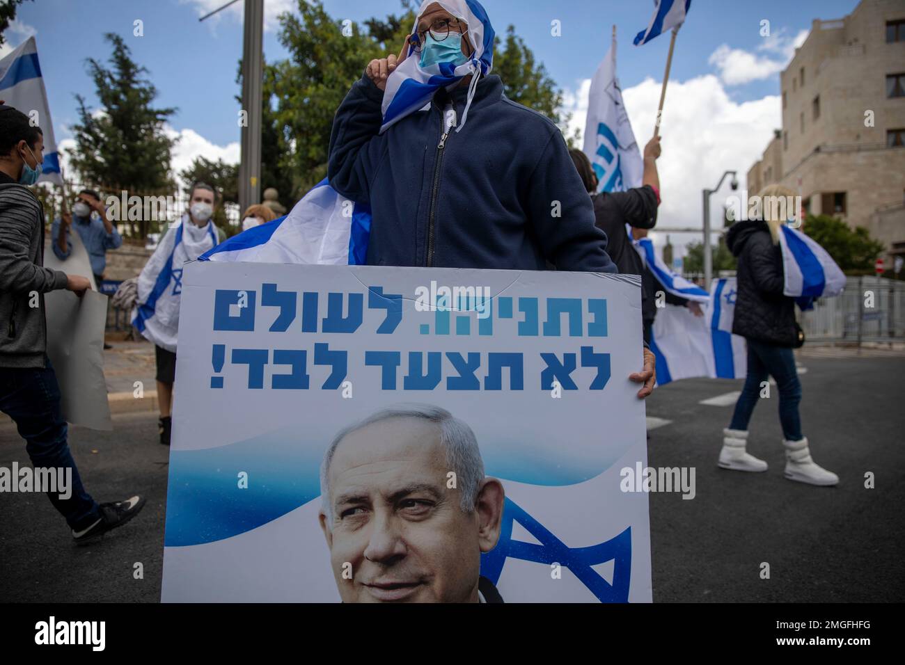 Supporters of Israel's Prime Minister Benjamin Netanyahu hold banners ...