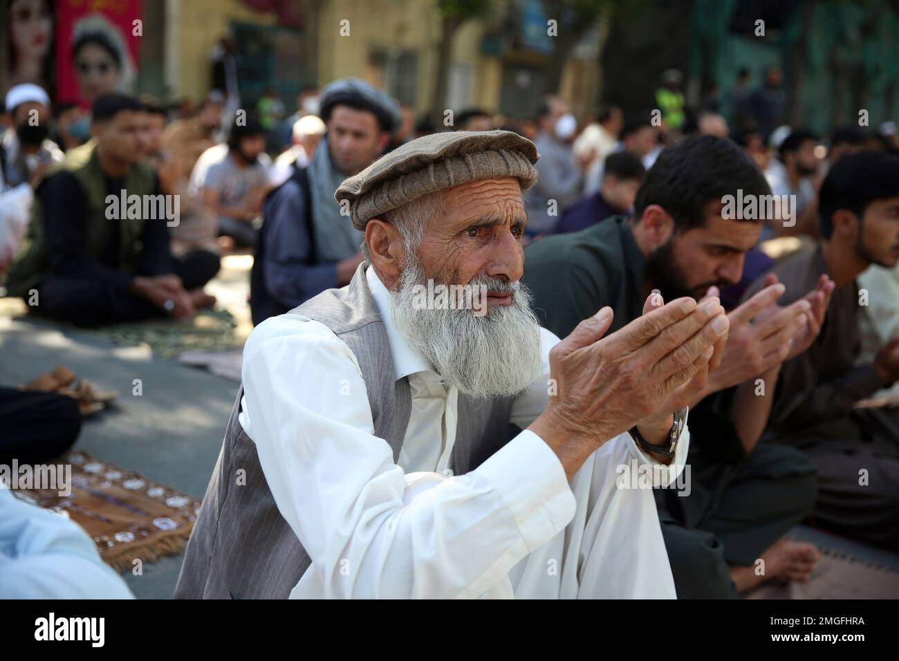 Men pray after the Eid al-Fitr prayers outside a mosque in Kabul ...