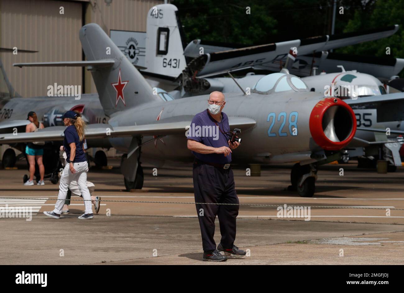 A visitor wears a mask at the Cavanaugh Flight Museum in Addison, Texas ...