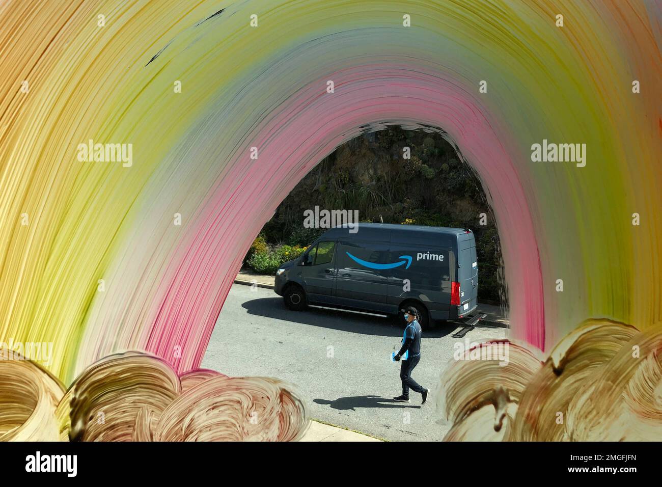 An Amazon Prime driver wears a mask while making deliveries during the ...