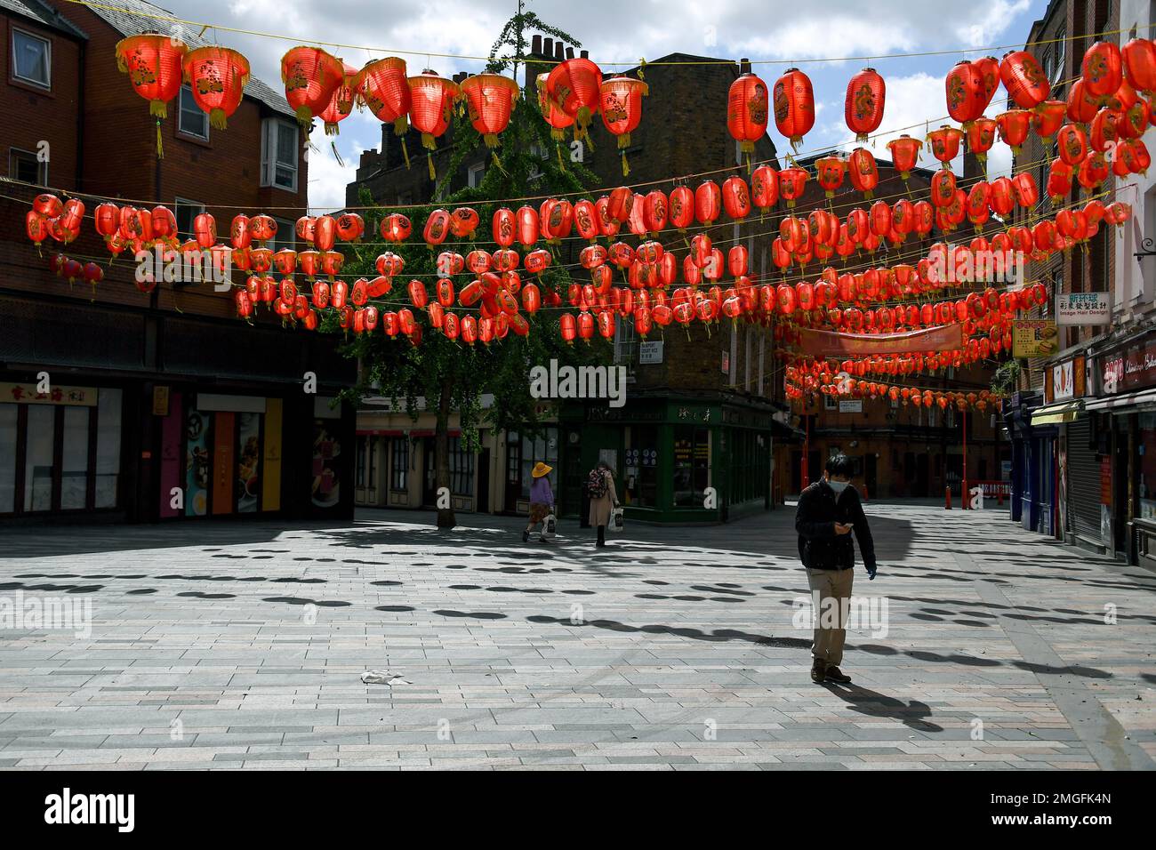 A man wears a face mask to protect against coronavirus as he walks in a ...