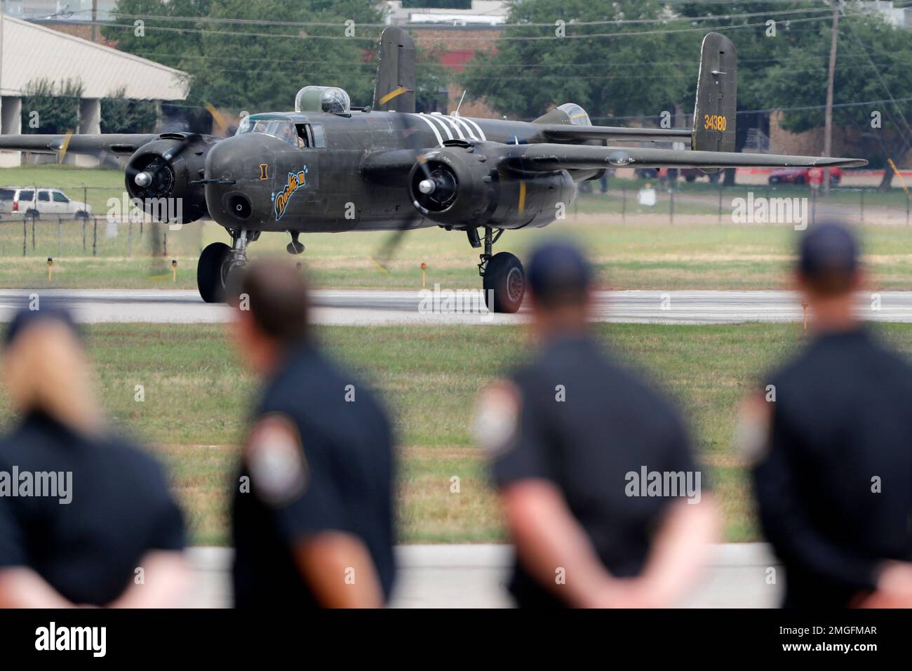 Members of the Addison Fire and Rescue line up along the flight line to ...