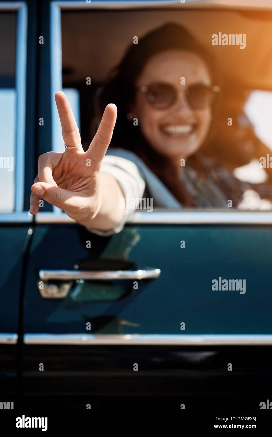 Were hitting the road, peace out. Cropped portrait of an attractive ...