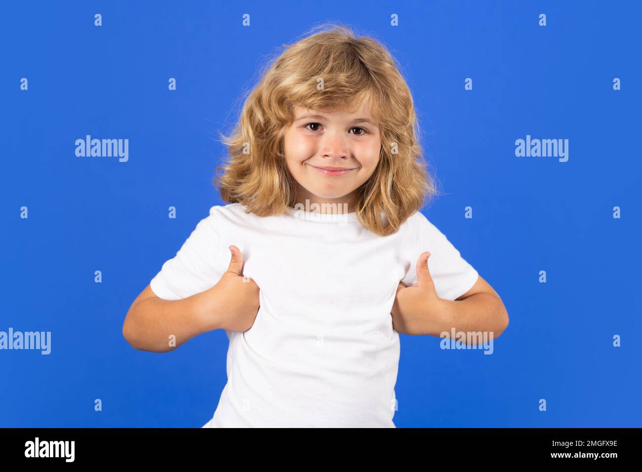 Child showing thumbs up on studio isolated background. Portrait of kid ...