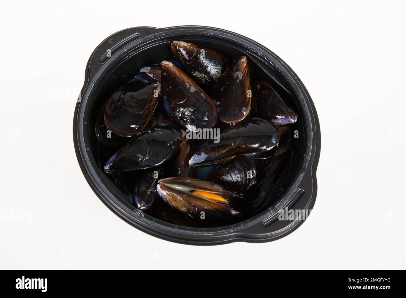 seafood mussels in plastic black plate on white background Stock Photo ...
