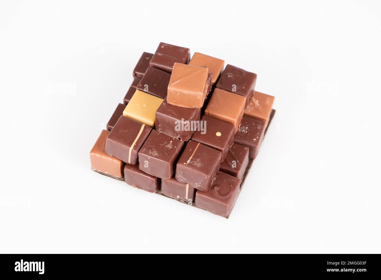 some square pyramid chocolate pralines in top view in white background ...