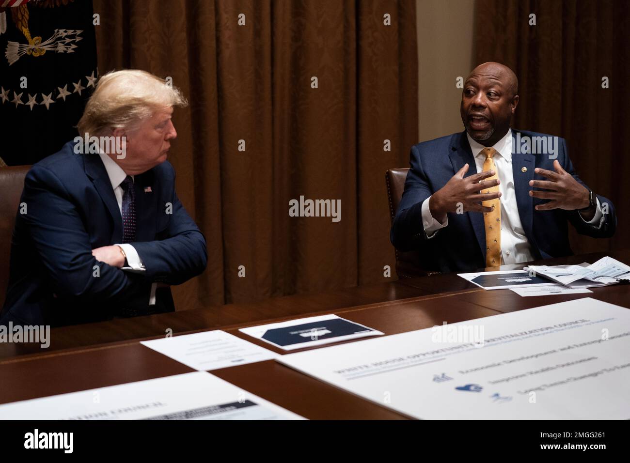 President Donald Trump listens as Sen. Tim Scott, R-S.C., speaks during ...