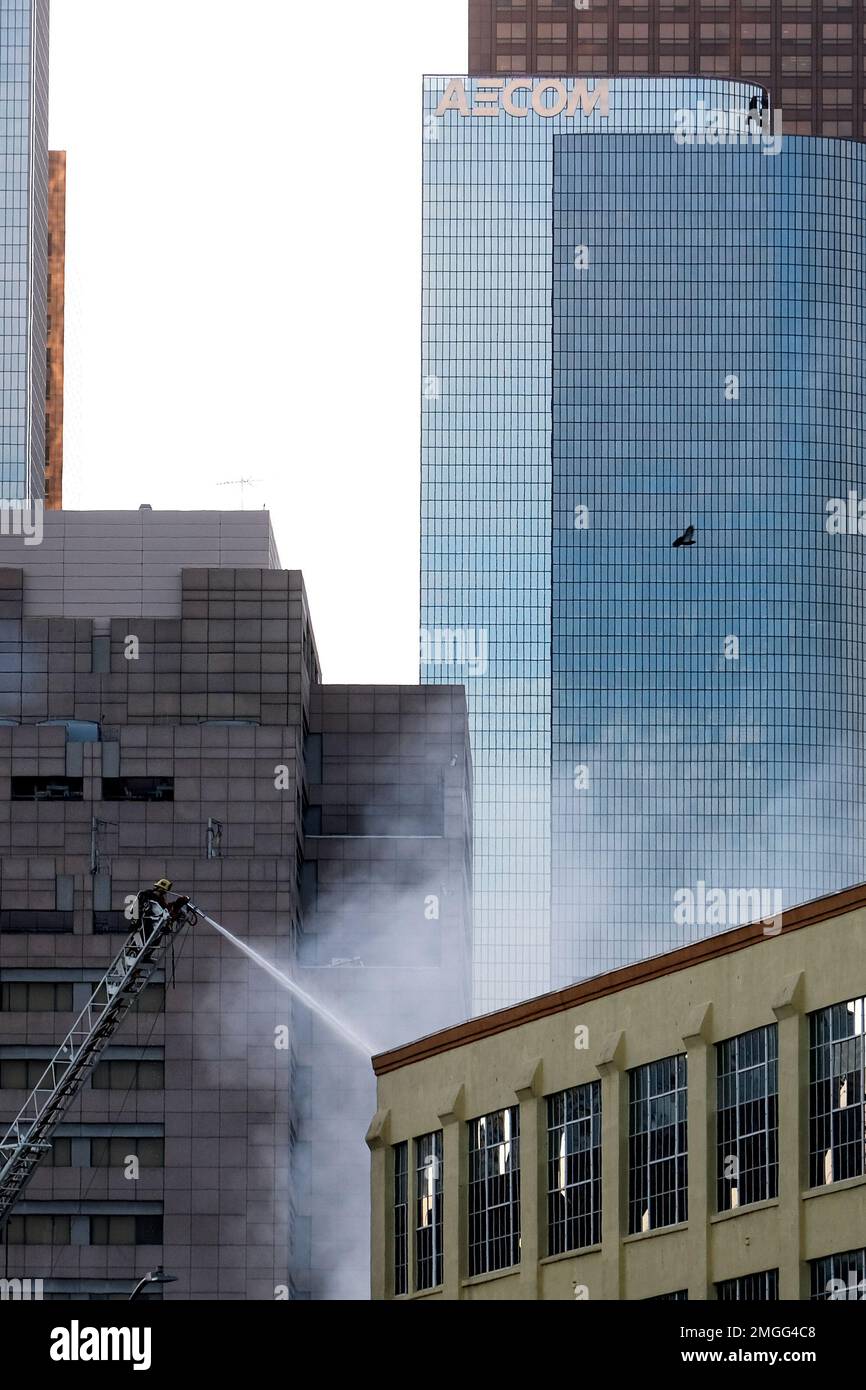 A Los Angeles Fire Department firefighter works the scene of a ...