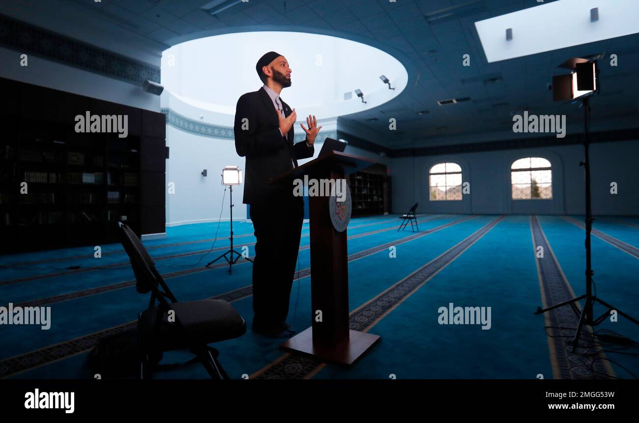 Imam Omar Suleiman speaks during an online broadcast from the empty ...