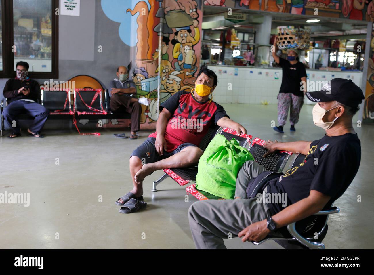 People sitting on spaced seating take a break from their work at a ...