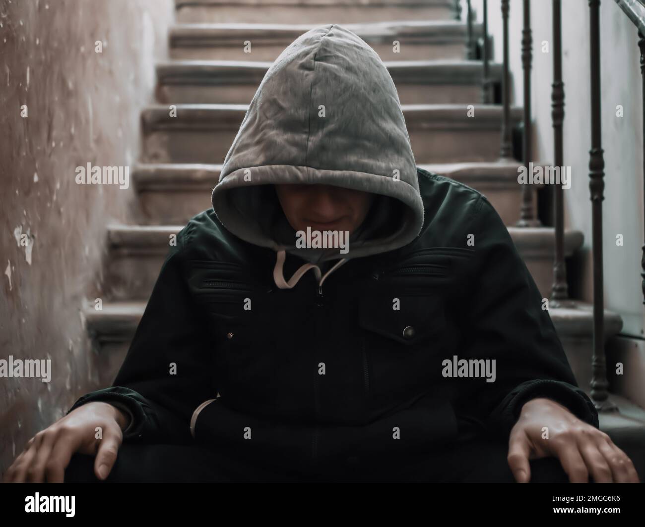 Depressed teenager in hood hi-res stock photography and images - Alamy