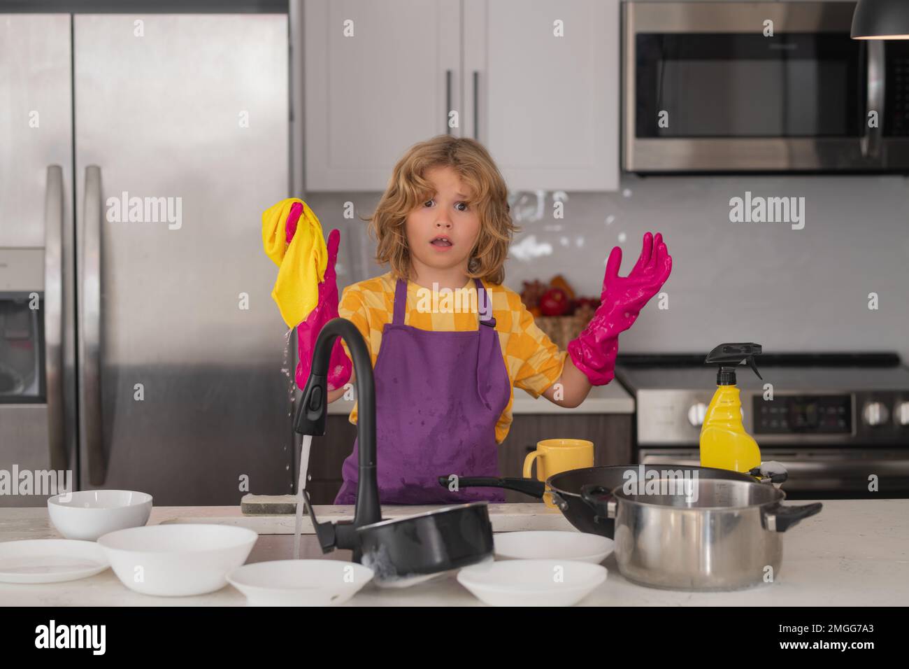 Cleaning at home. Child helping with household, wiping dishes in ...