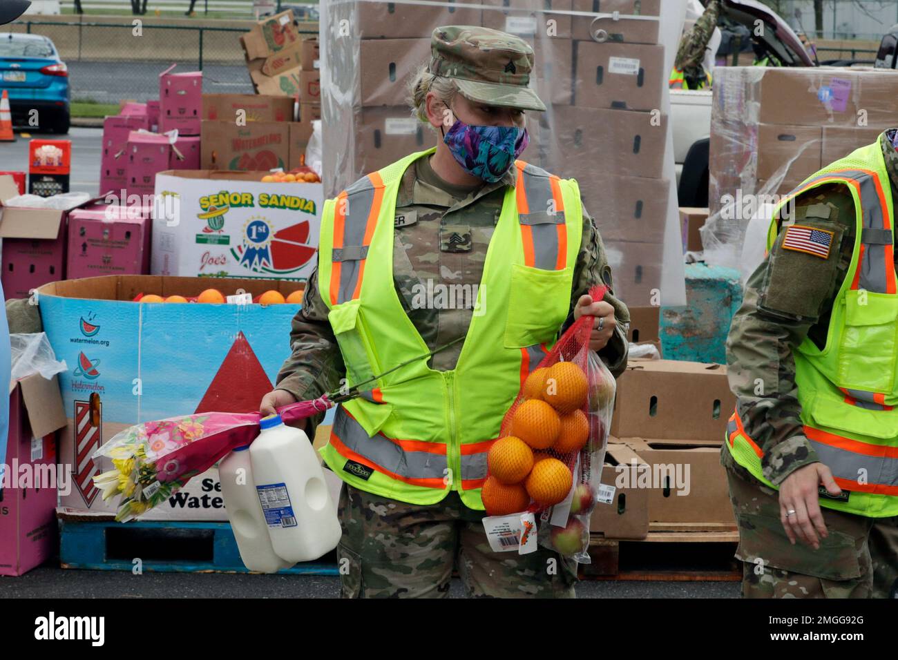 Sgt. Kelley Cremer carries food and flowers to give to recipients at ...