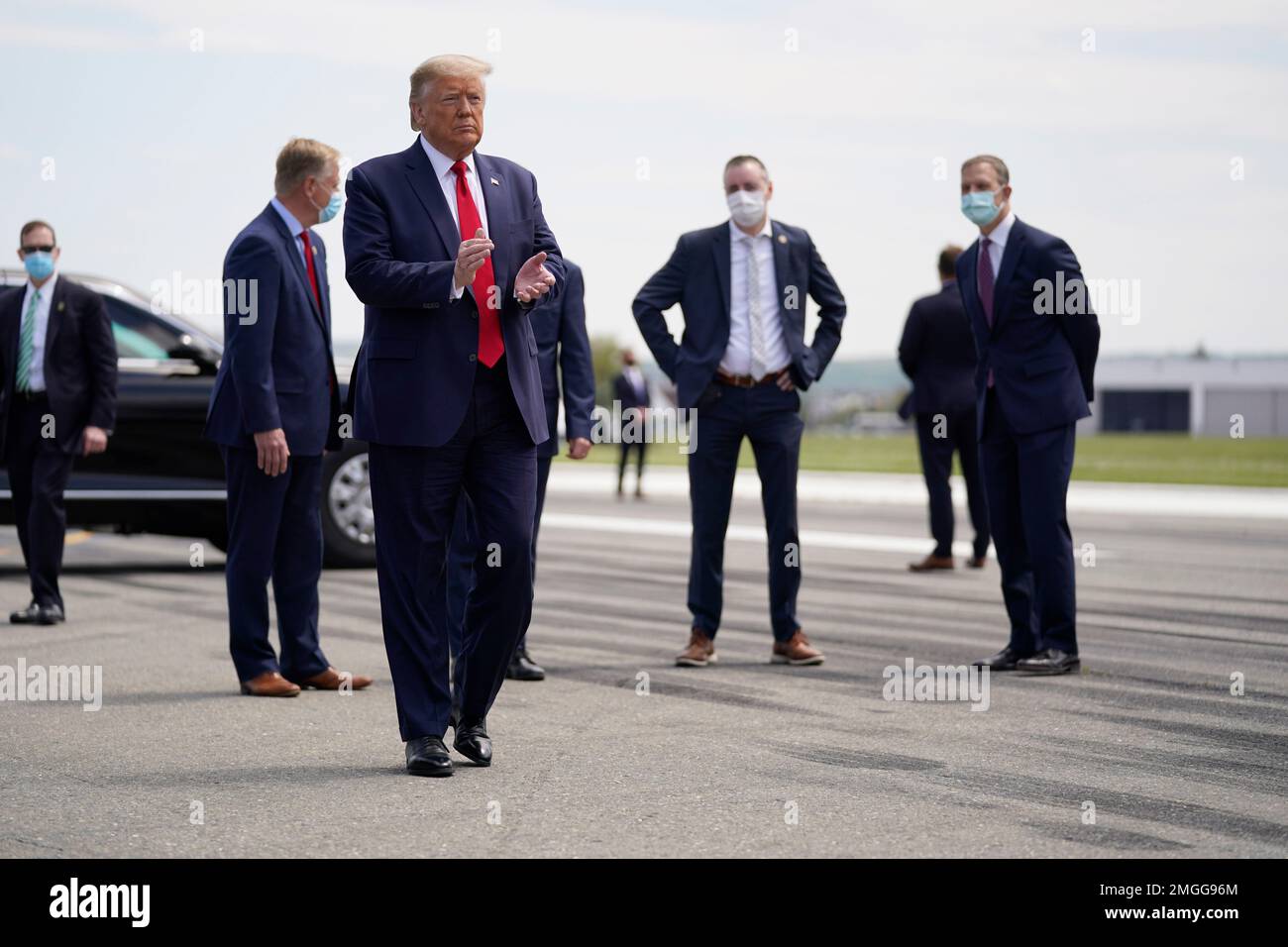 President Donald Trump pauses to clap after exiting Air Force One at ...