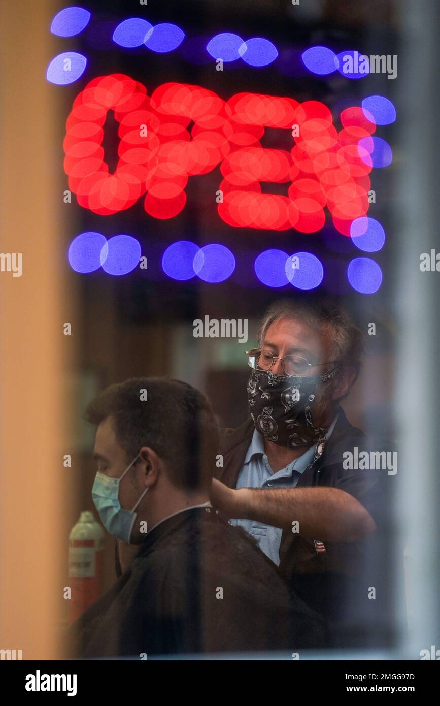Owner Paul Furrer cuts the hair of Jeff Jones at Rick's Barber Shop ...