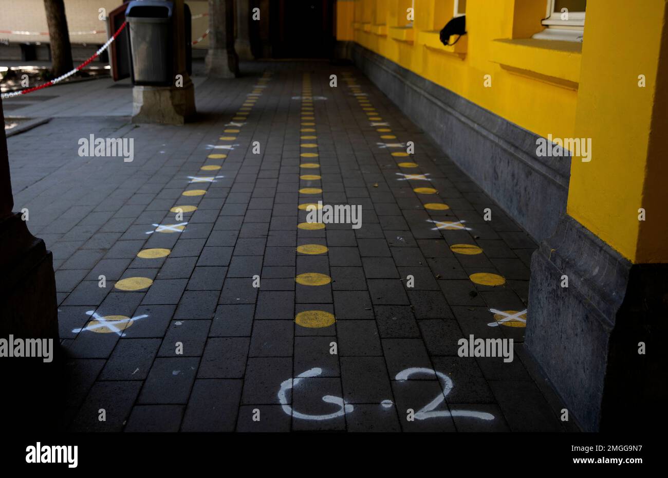 Spray painted guide marks on the pavement outside a classroom, to guide ...