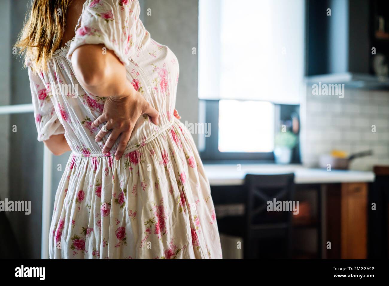 Pregnant woman expecting baby with aches, nausea, headache and backpain ...