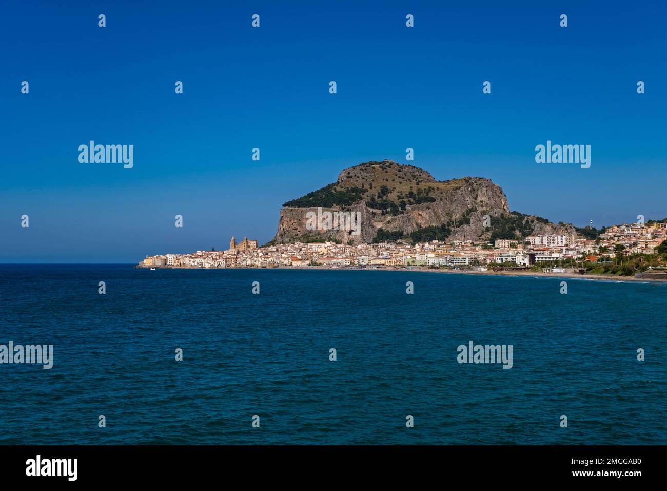 View across the sea to the medieval town of Cefalu, located on the ...