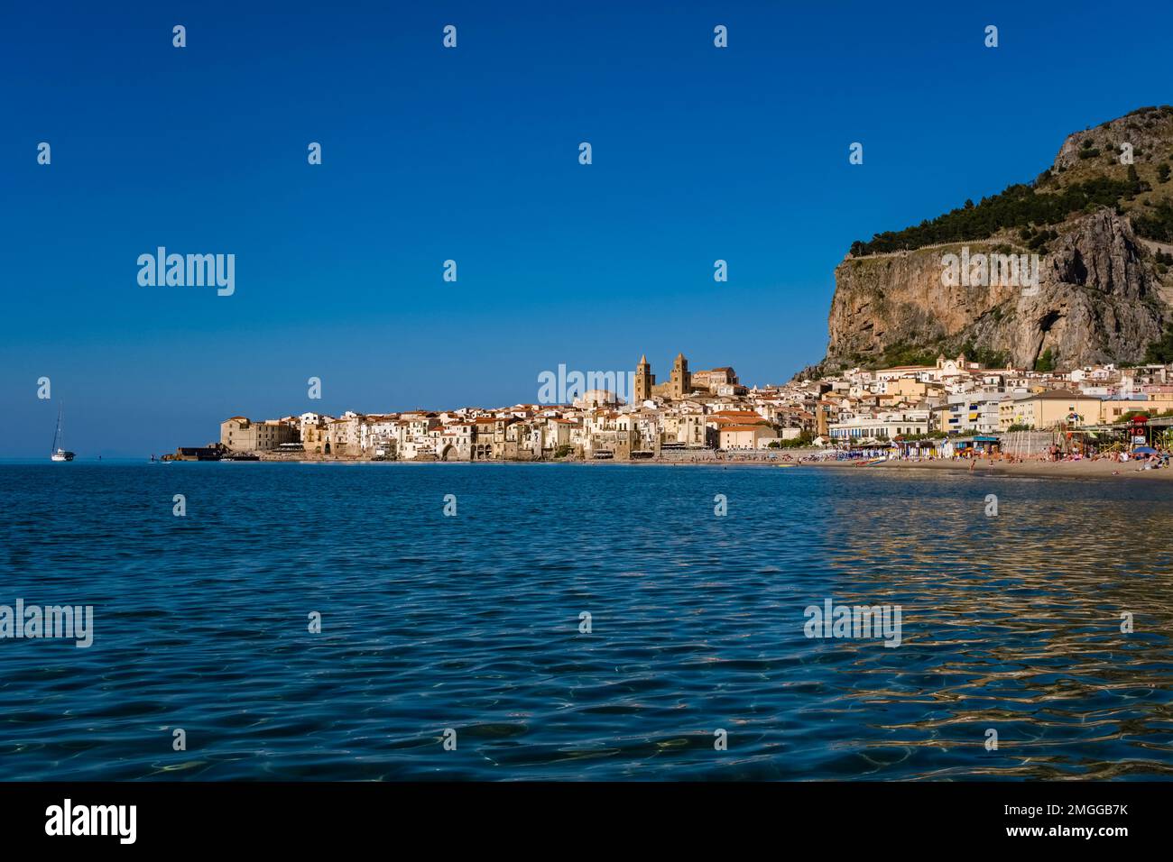 View across the sea to the medieval town of Cefalu, located on the ...