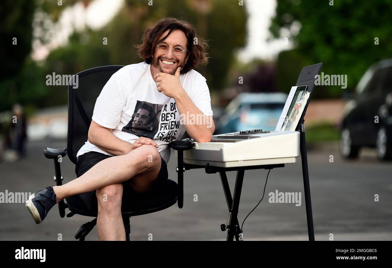 Musician Adam Chester poses for a portrait on his street after ...