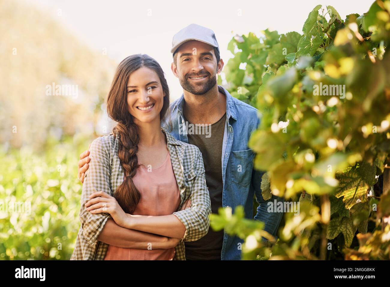Farming is all about faith. Portrait of two happy young farmers posing ...