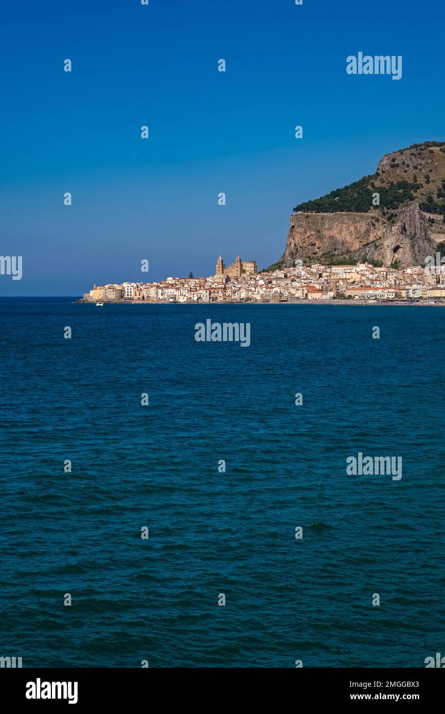 View across the sea to the medieval town of Cefalu, located on the ...