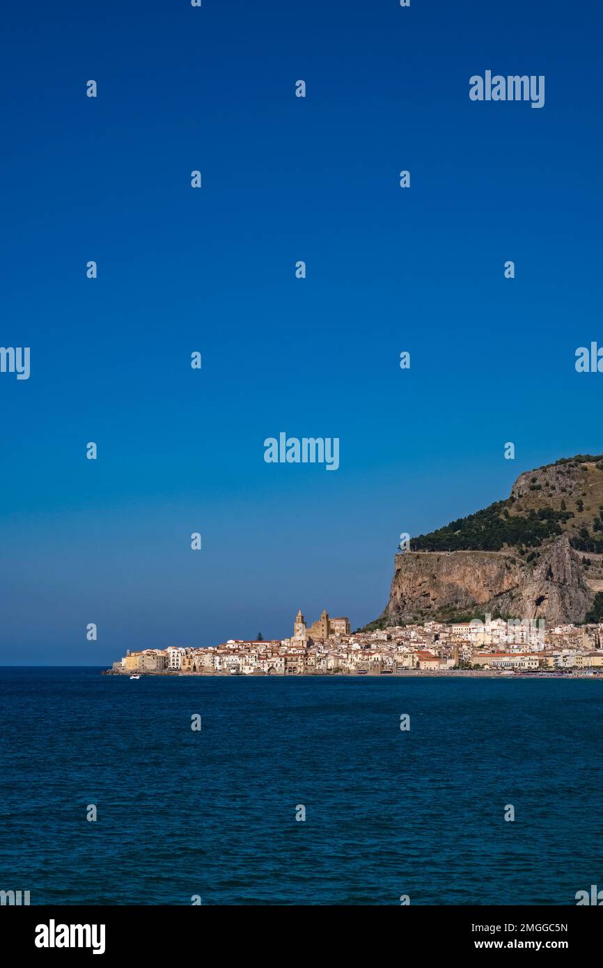 View across the sea to the medieval town of Cefalu, located on the ...