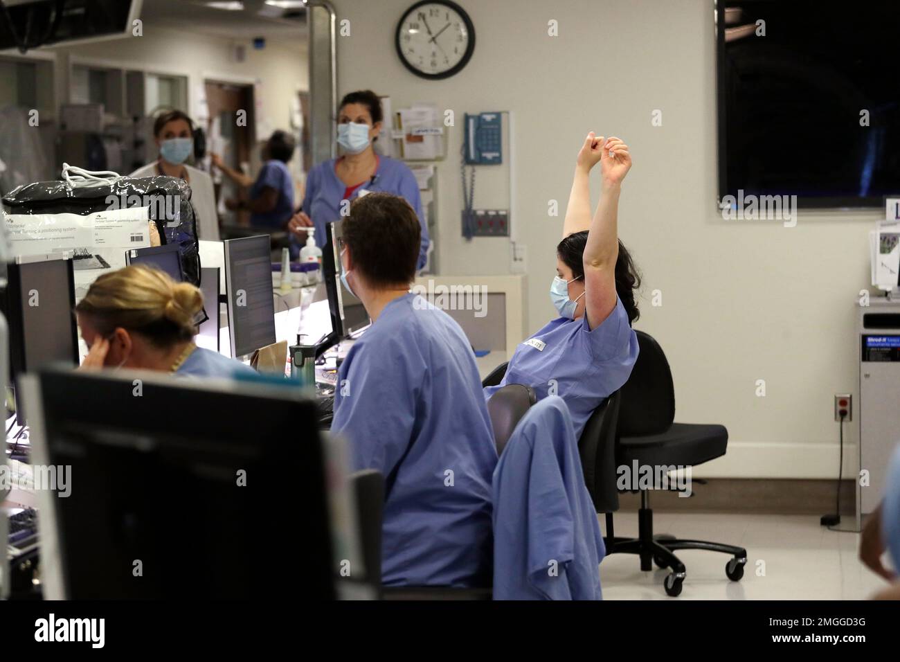 Registered nurse Caitlin Schripsema stretches as she sits at the nurse ...