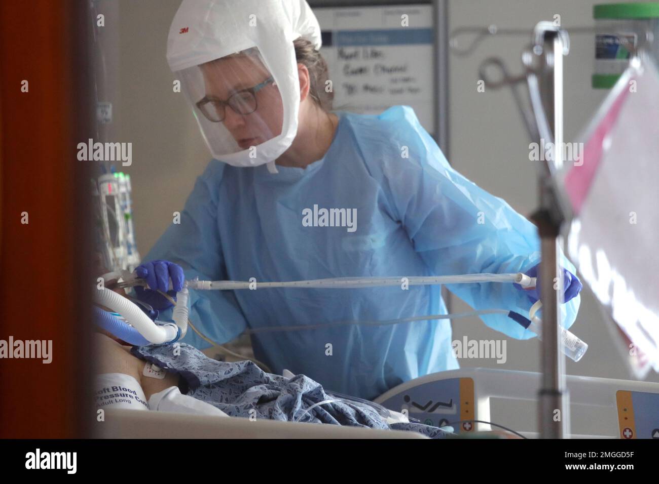 Registered nurse Beth Andrews works with a patient in the COVID-19 ...