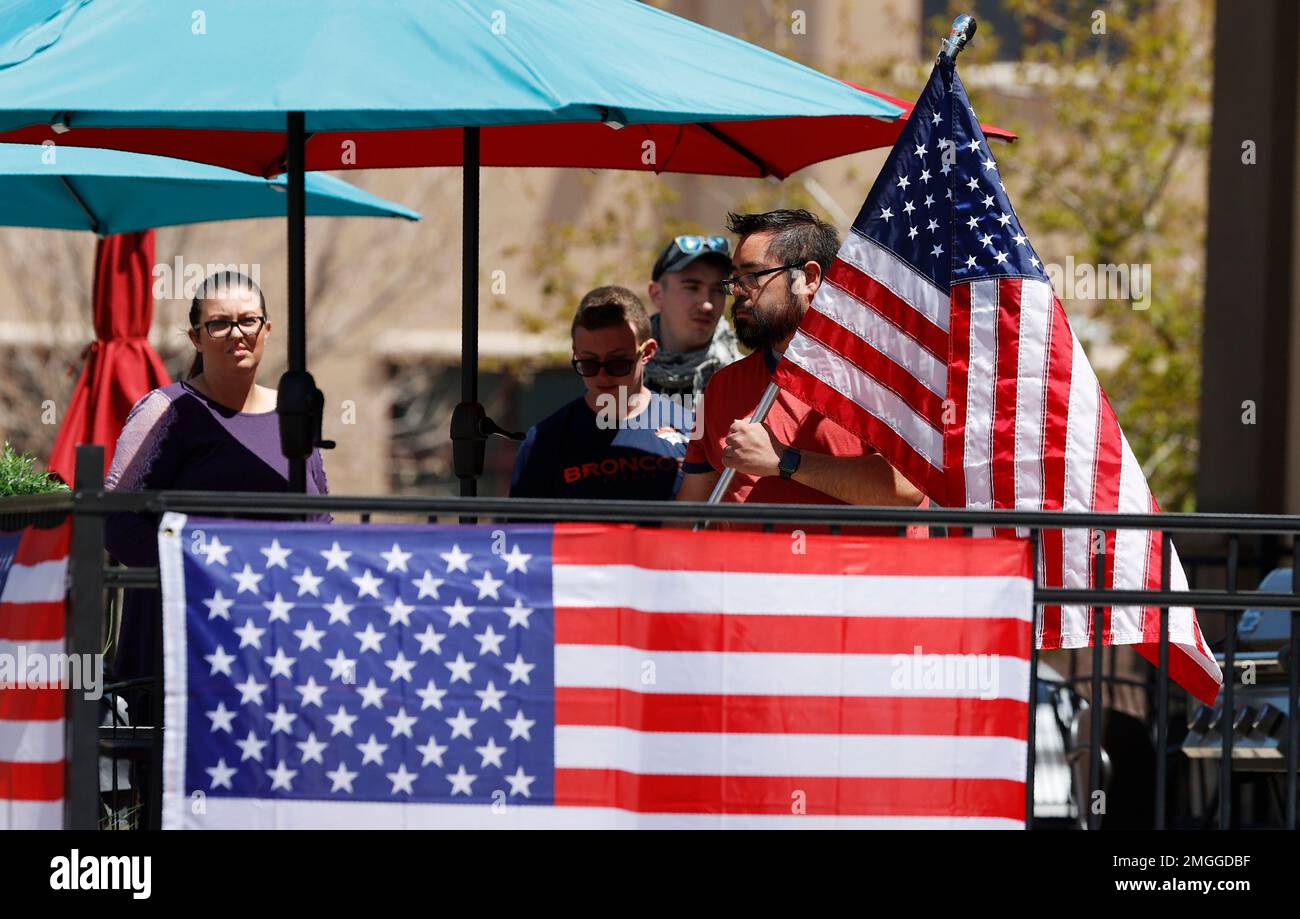 As his wife and co-owner, April, back left, looks on, Jesse Arellano ...