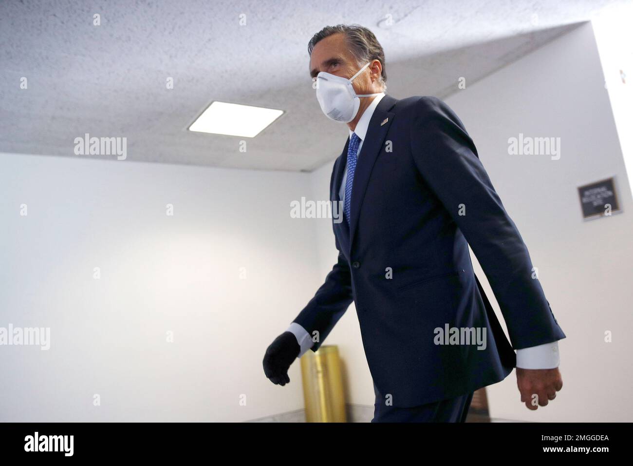 Sen. Mitt Romney, R-Utah, wears a face mask to protect against the ...