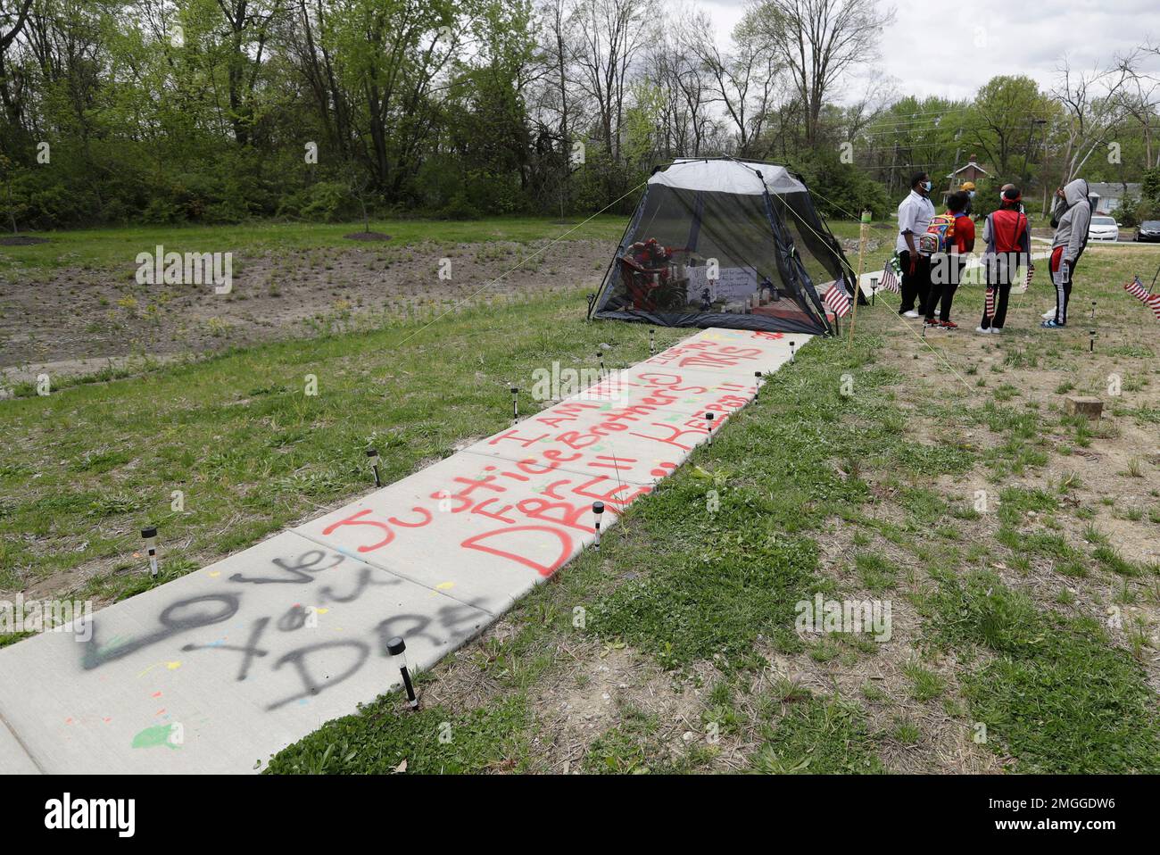 Guests stand by a memorial for Dreasjon Reed, Tuesday, May 12, 2020, in ...