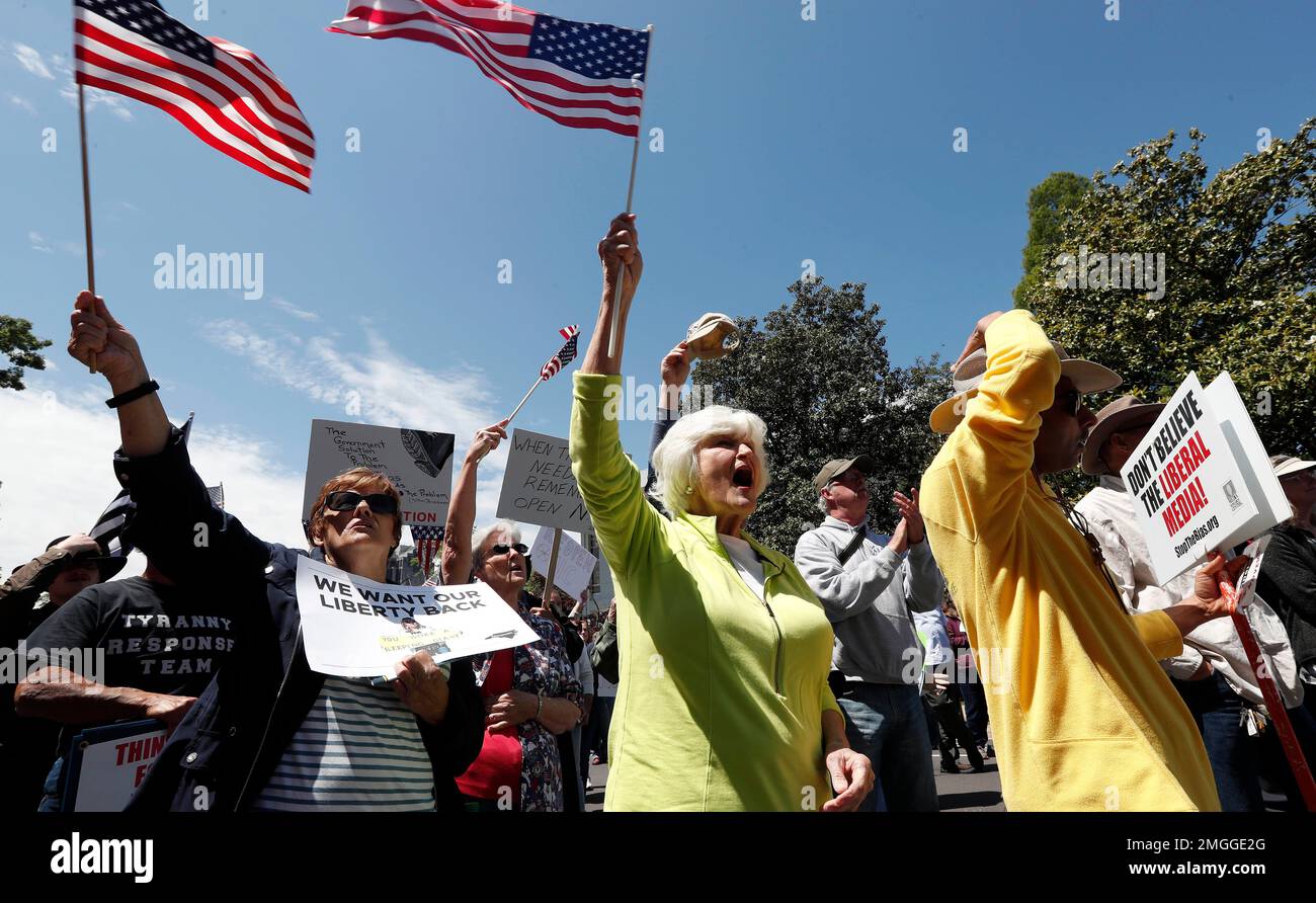 People gather outside the executive mansion to protest stay-at-home ...