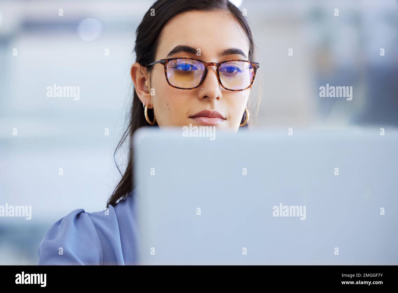 Business woman, glasses and working on laptop in office, agency and ...