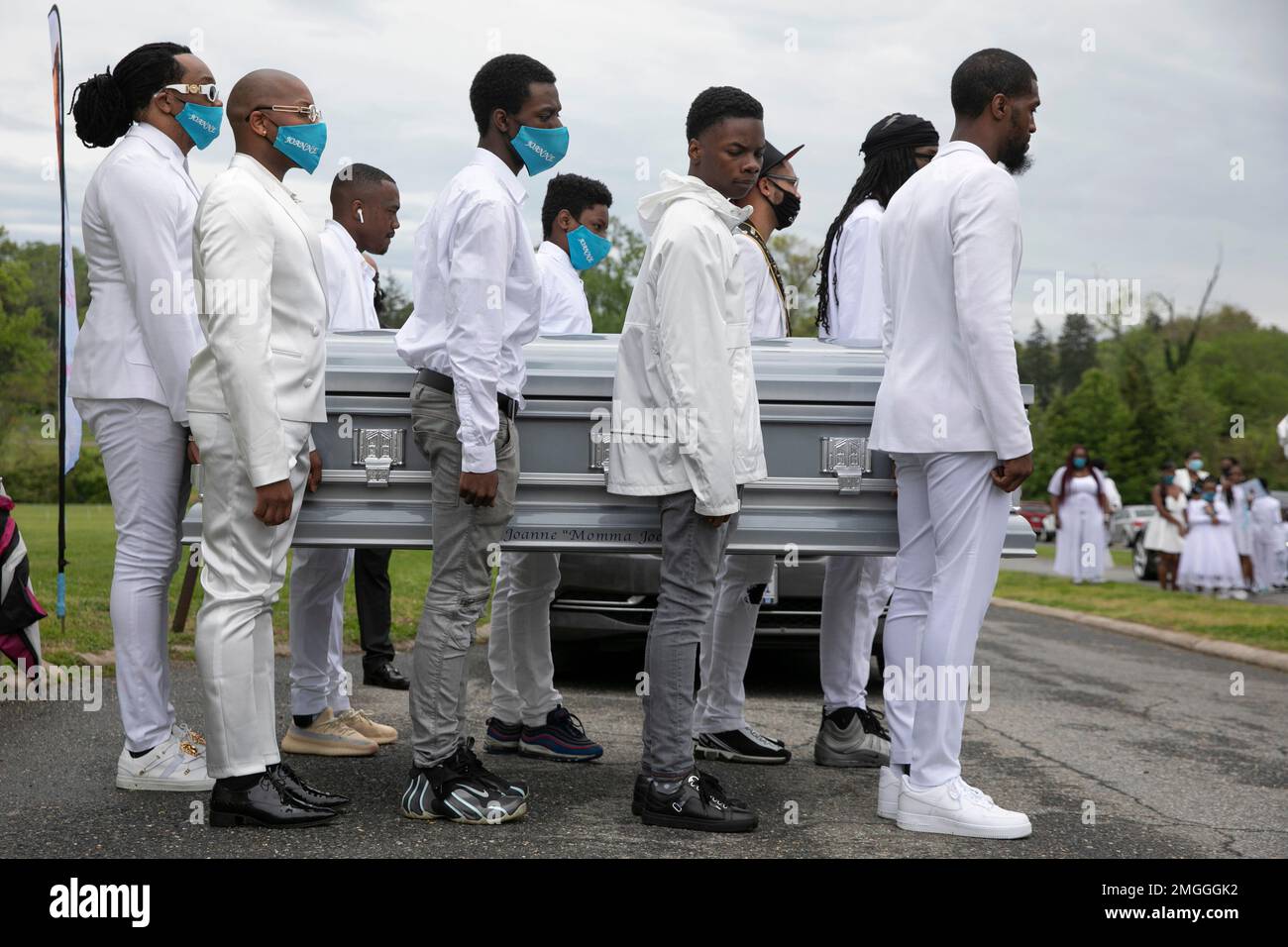 Family including Iran "Bang" Paylor, of Washington, far left, carry the ...