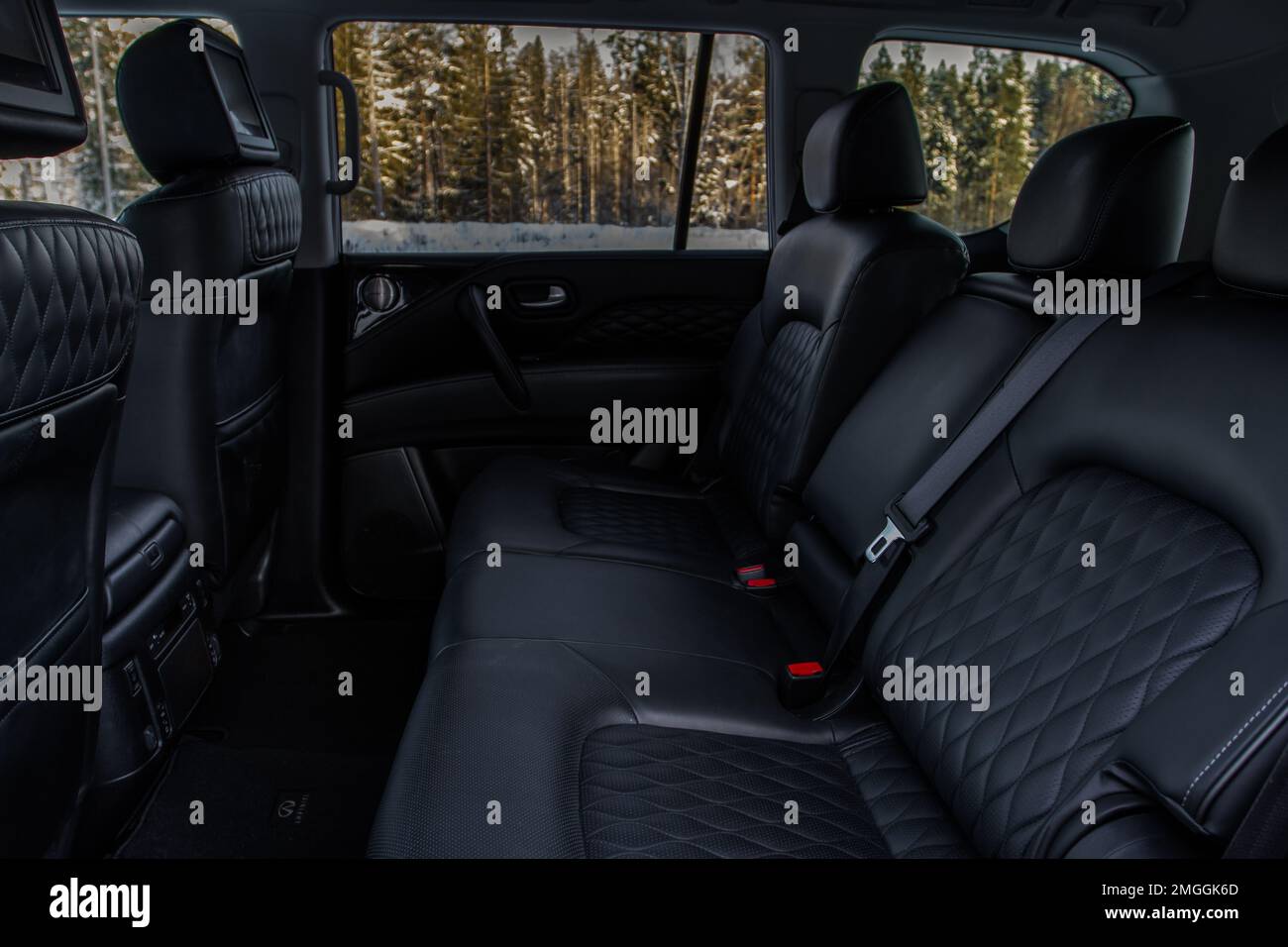 Modern car interior. Clean rear seats with the belts. Three rear seats ...