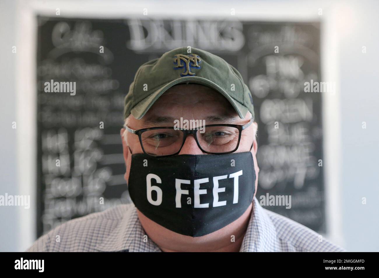 Mike Novak poses for a photograph as he wears a message requesting ...