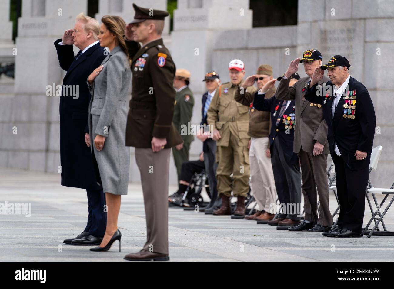 World War II veterans salute as Taps is played during a ceremony at the ...