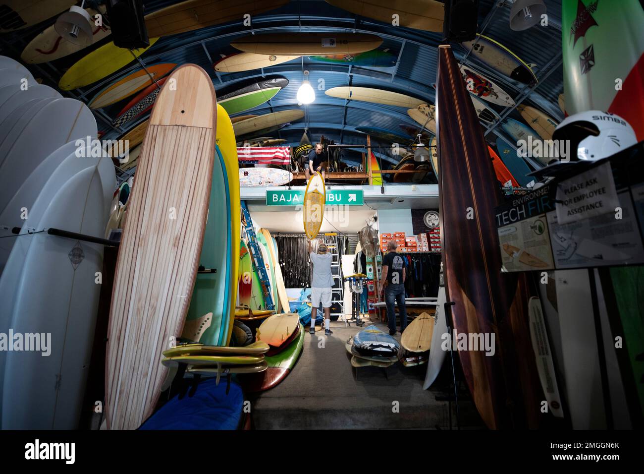 Surf shop workers move surfboards as Bird's Surf Shed opens Friday, May ...