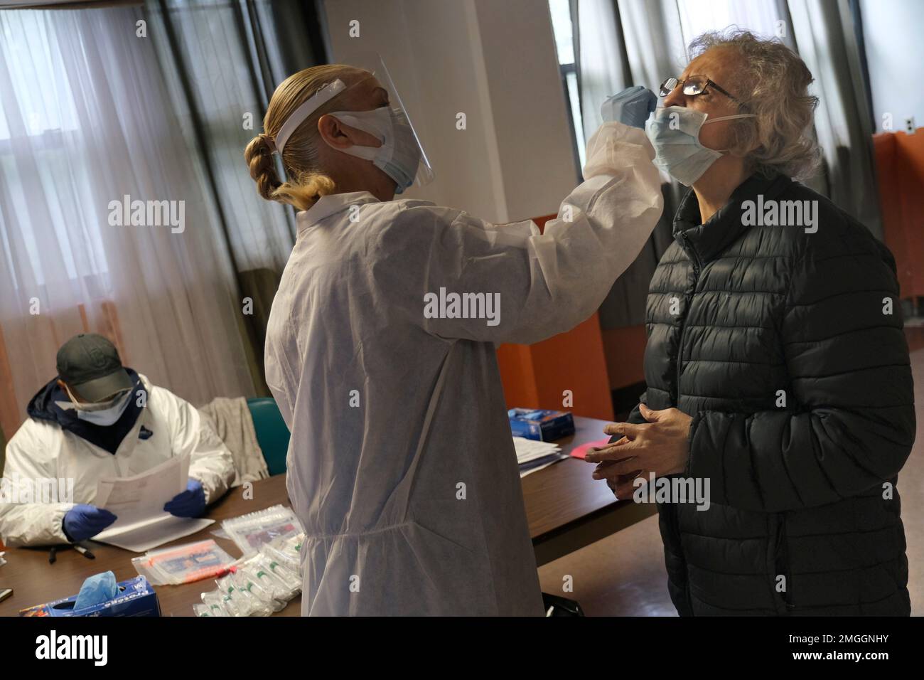 Aida Rivera, right, a resident of senior housing, gets tested for COVID ...