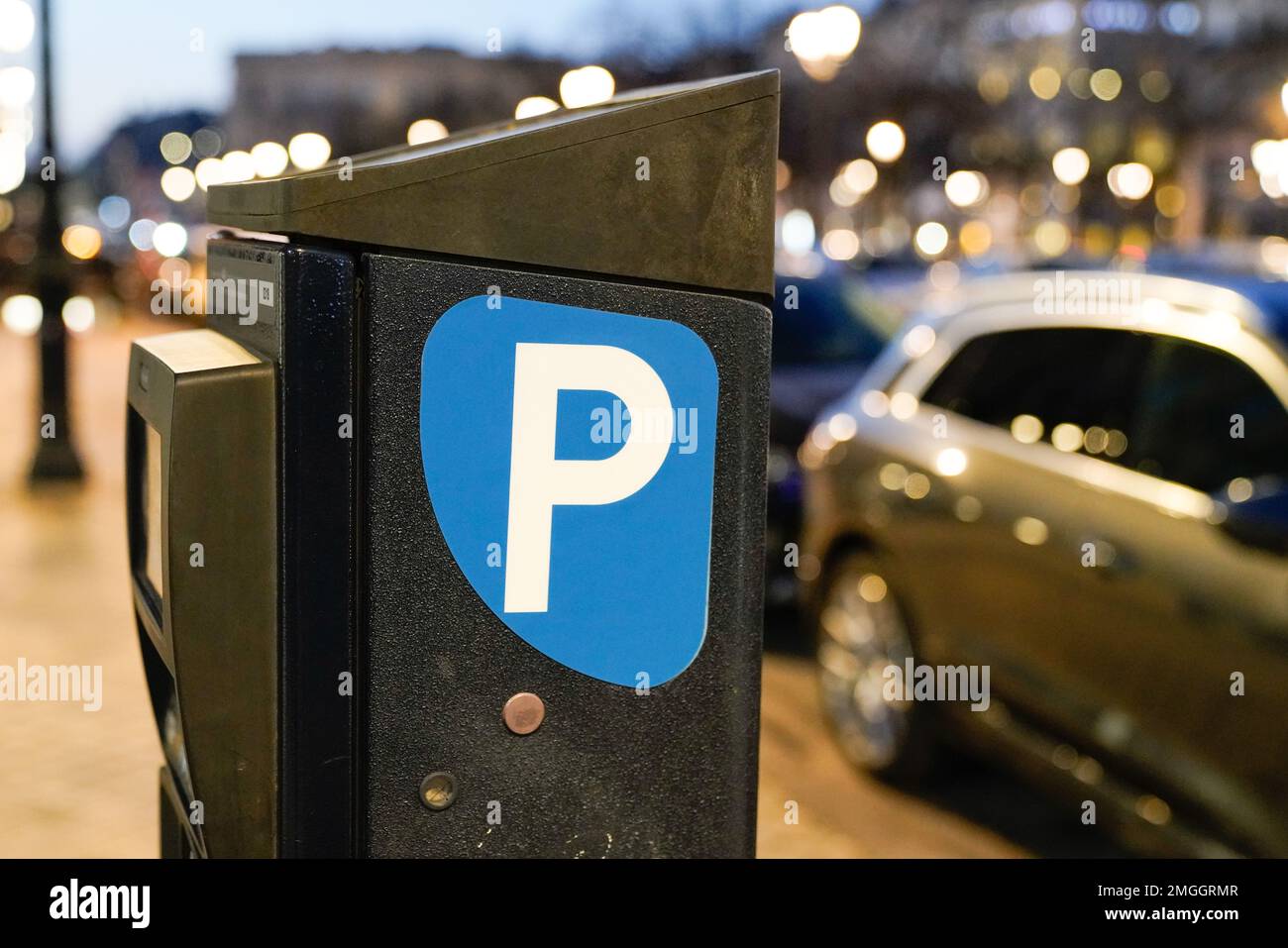 parking meter sign blue white p car parked in city street on evening ...