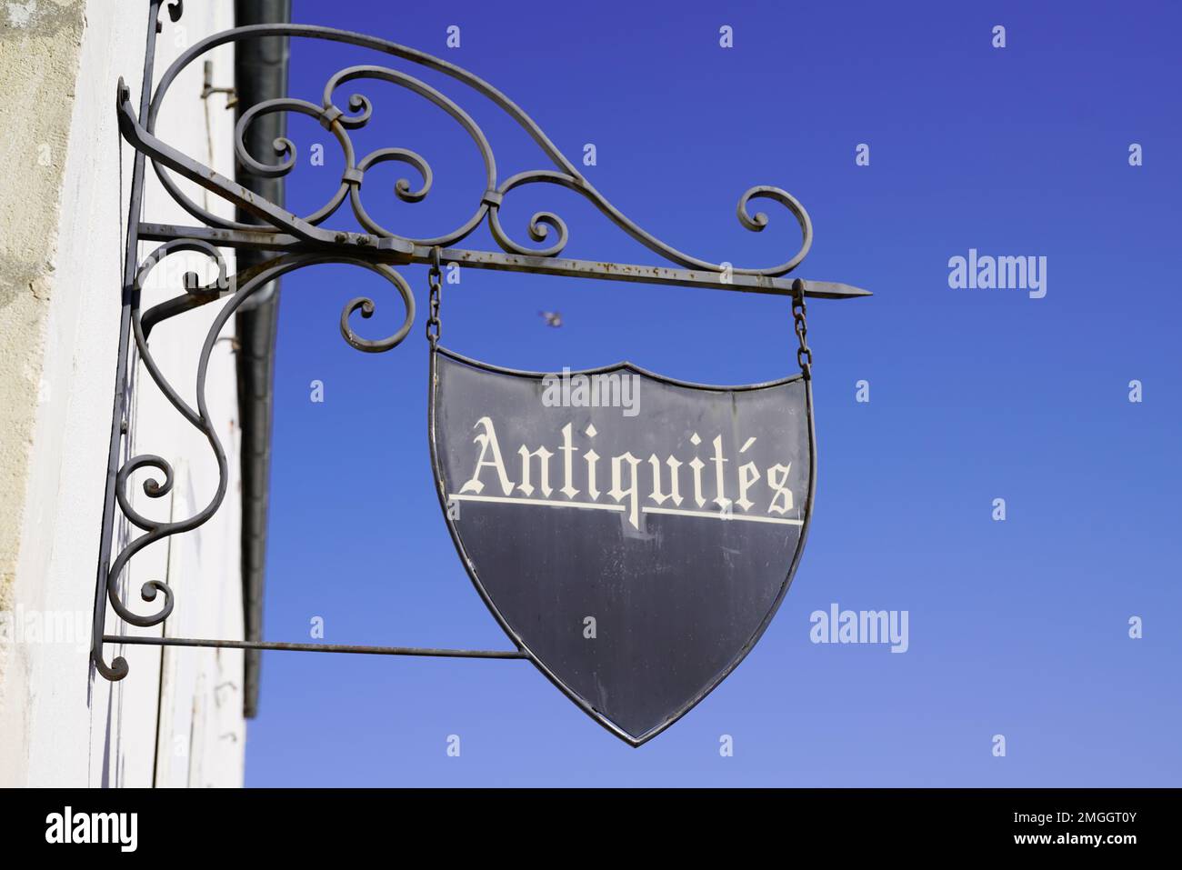 store facade wall panel in the street with retro text antiques in ...