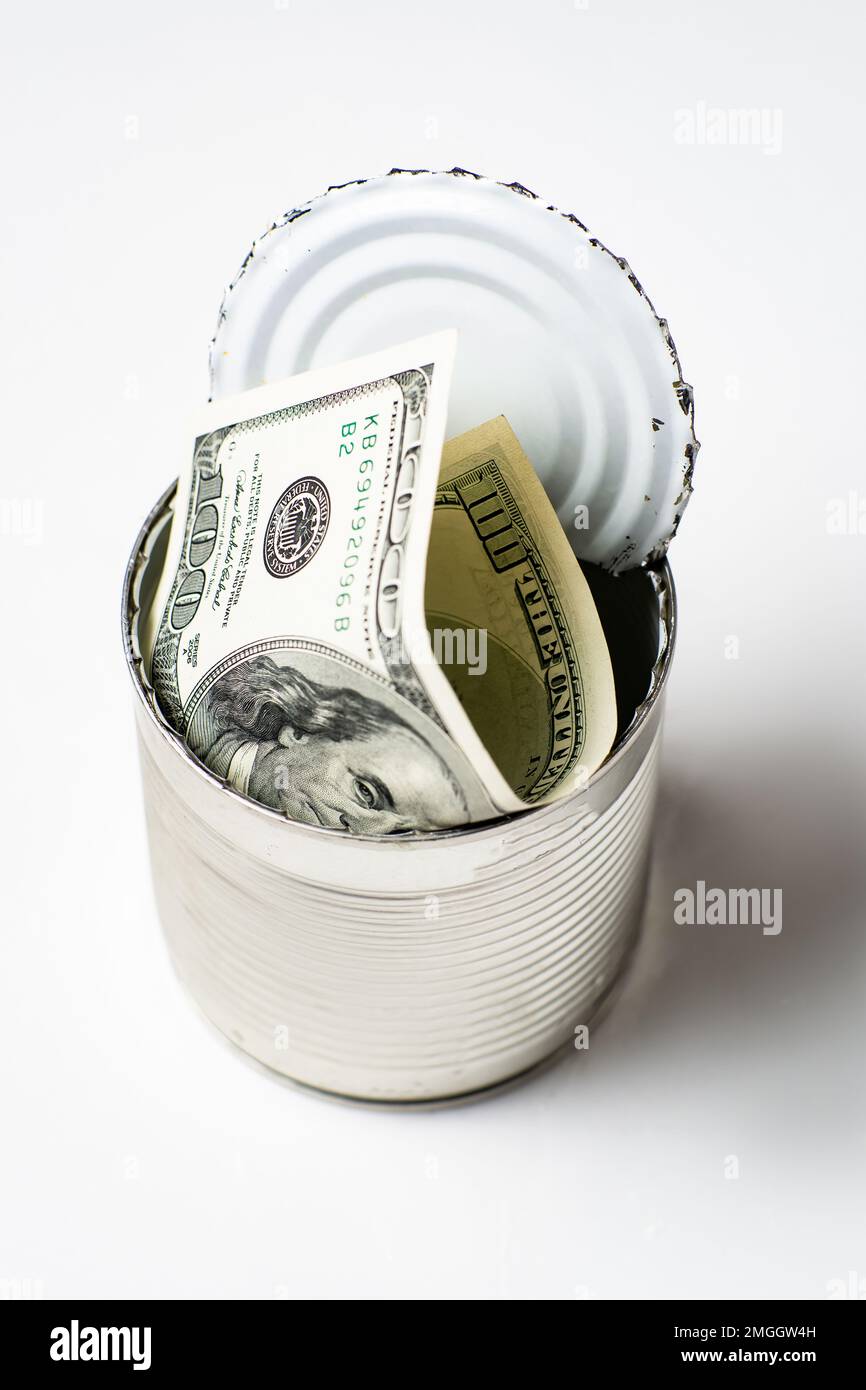 Dollars in an open tin can. Safeguarding cash, stash concept. Time to ...