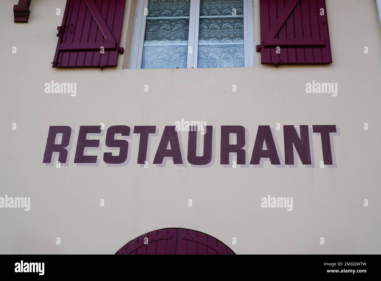 restaurant text sign paint on wall facade french building city street ...