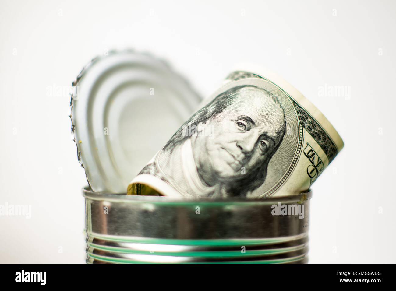 Dollars in an open tin can. Safeguarding cash, stash concept. Time to ...