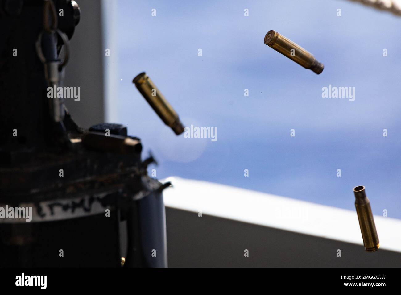 7.62mm round shells fall out of a M240B medium machine gun during a ...